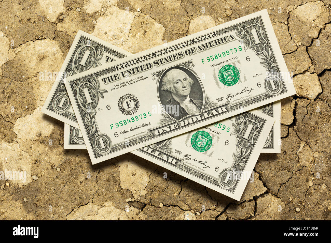 Dollar banknotes on dry soil background in closeup Stock Photo - Alamy