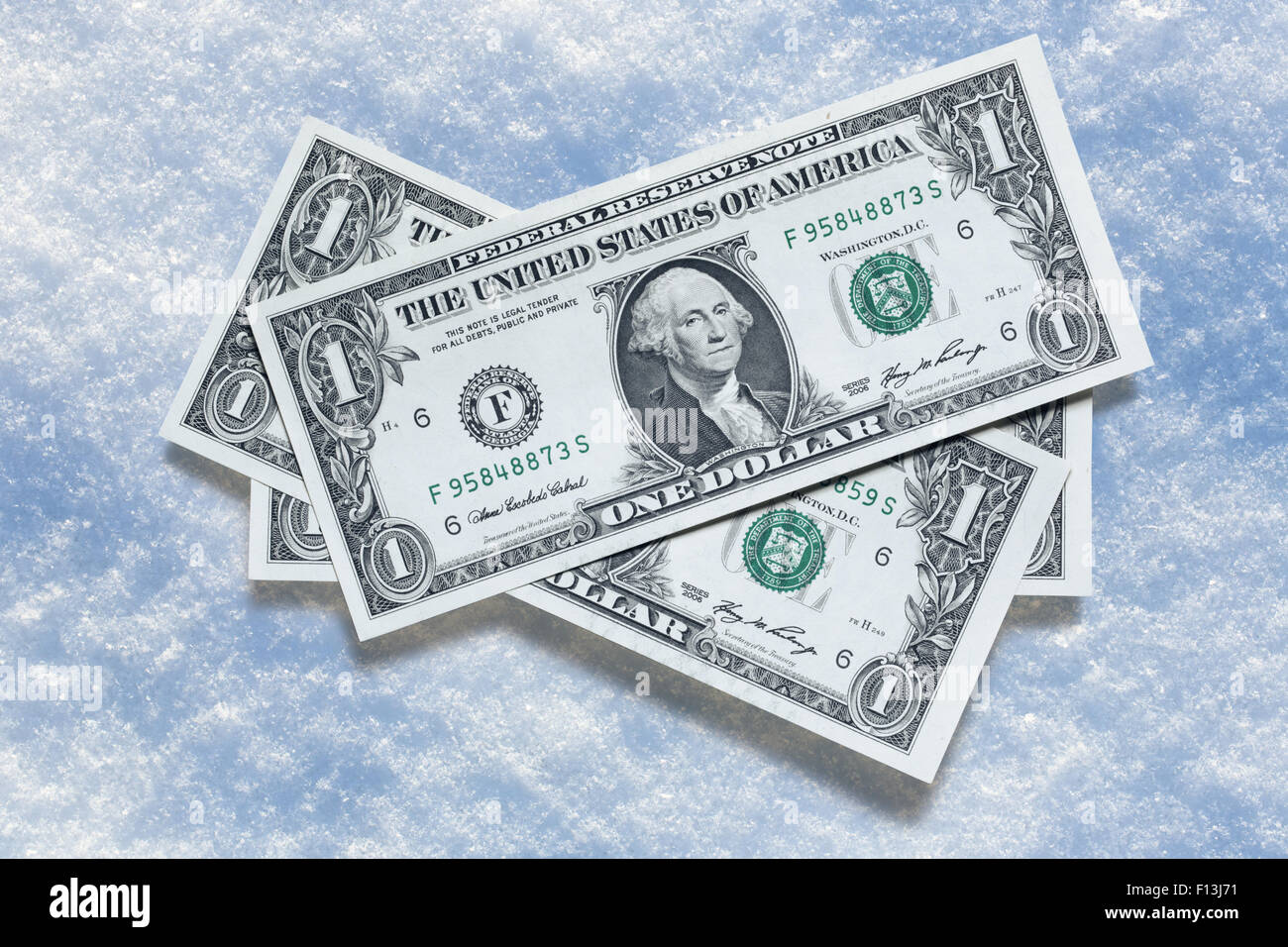 Dollar banknotes on snow background in closeup Stock Photo - Alamy