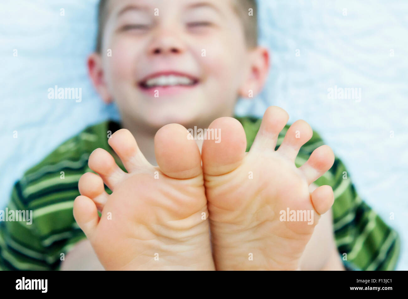 Boy smiling toes Stock Photo - Alamy