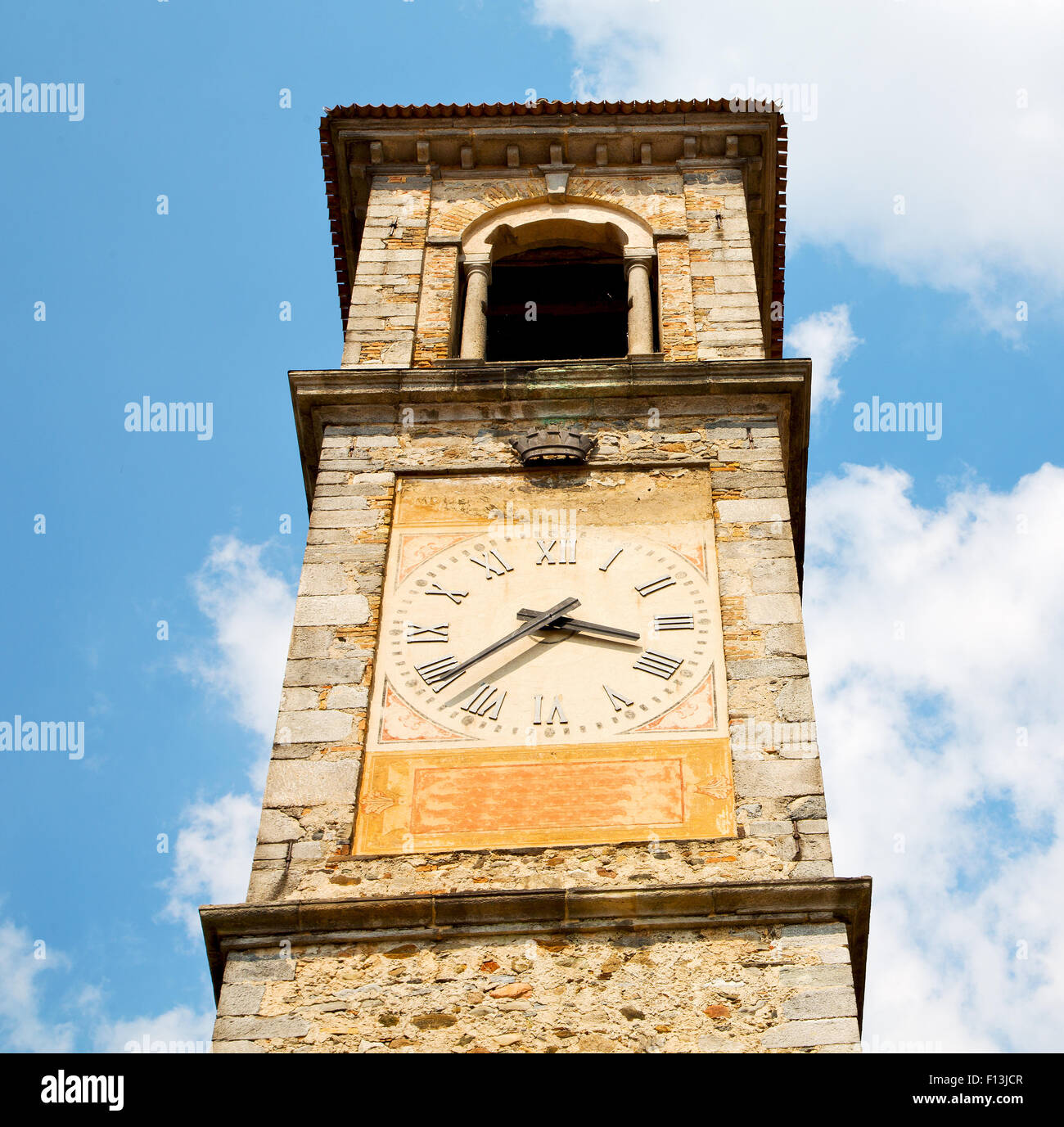 ancien clock tower in italy europe old stone and bell Stock Photo - Alamy