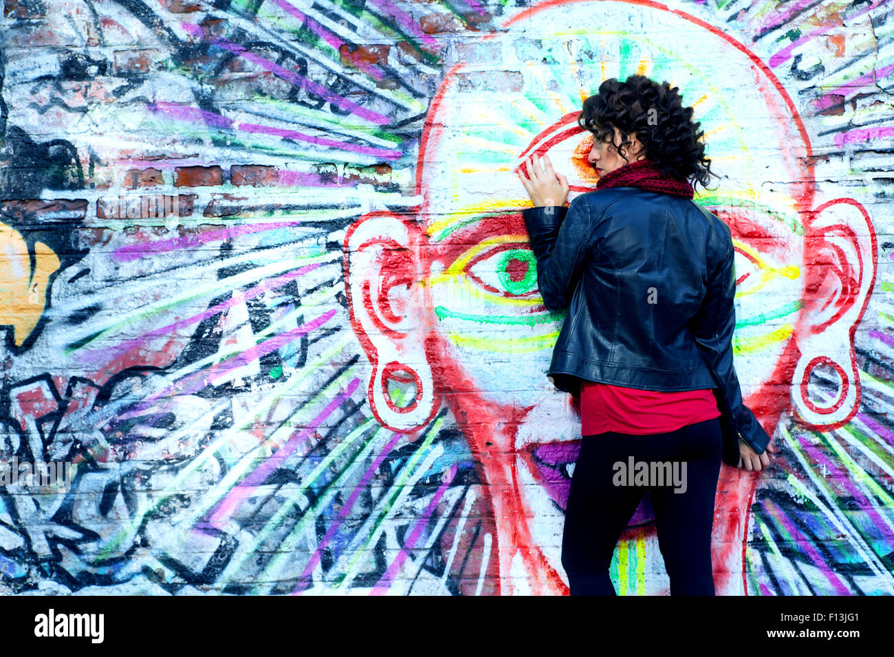Gorgeous brunette woman posing with spiritual graffiti head on the ...