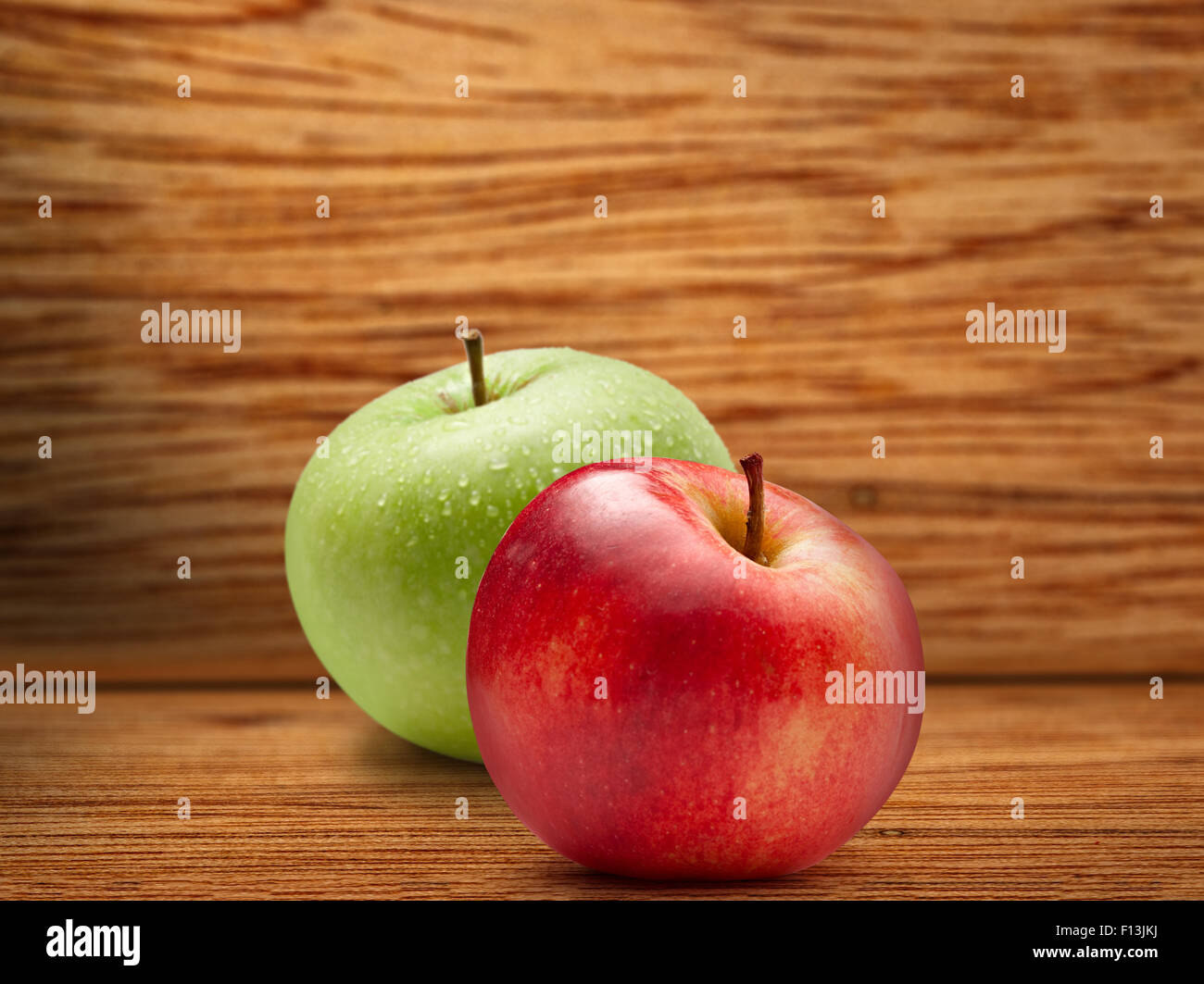 Fresh red and green apple on wooden background Stock Photo - Alamy