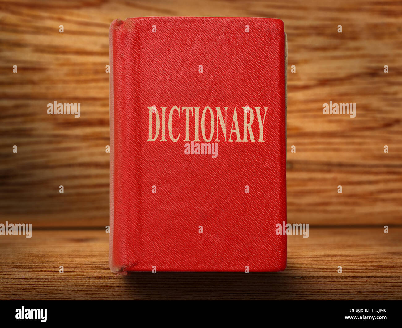 Old red dictionary on wooden background closeup Stock Photo - Alamy