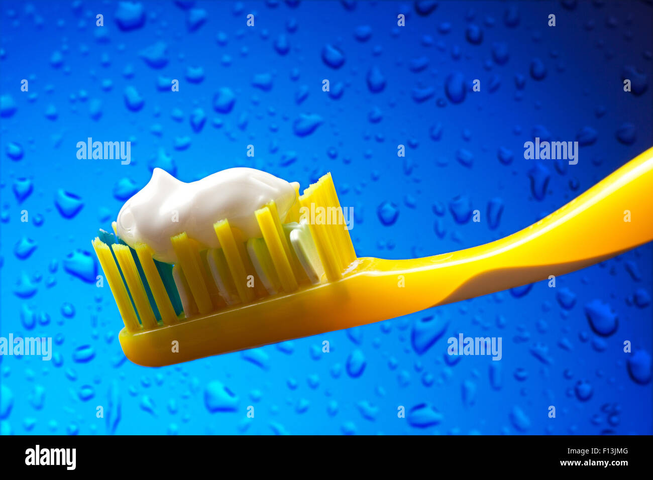 Toothbrush and toothpaste on blue water background Stock Photo - Alamy