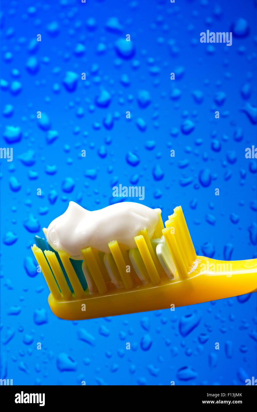 Toothbrush and toothpaste on blue water background Stock Photo - Alamy
