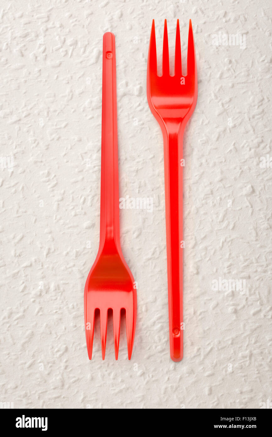 Red plastic forks vertical in close up Stock Photo - Alamy