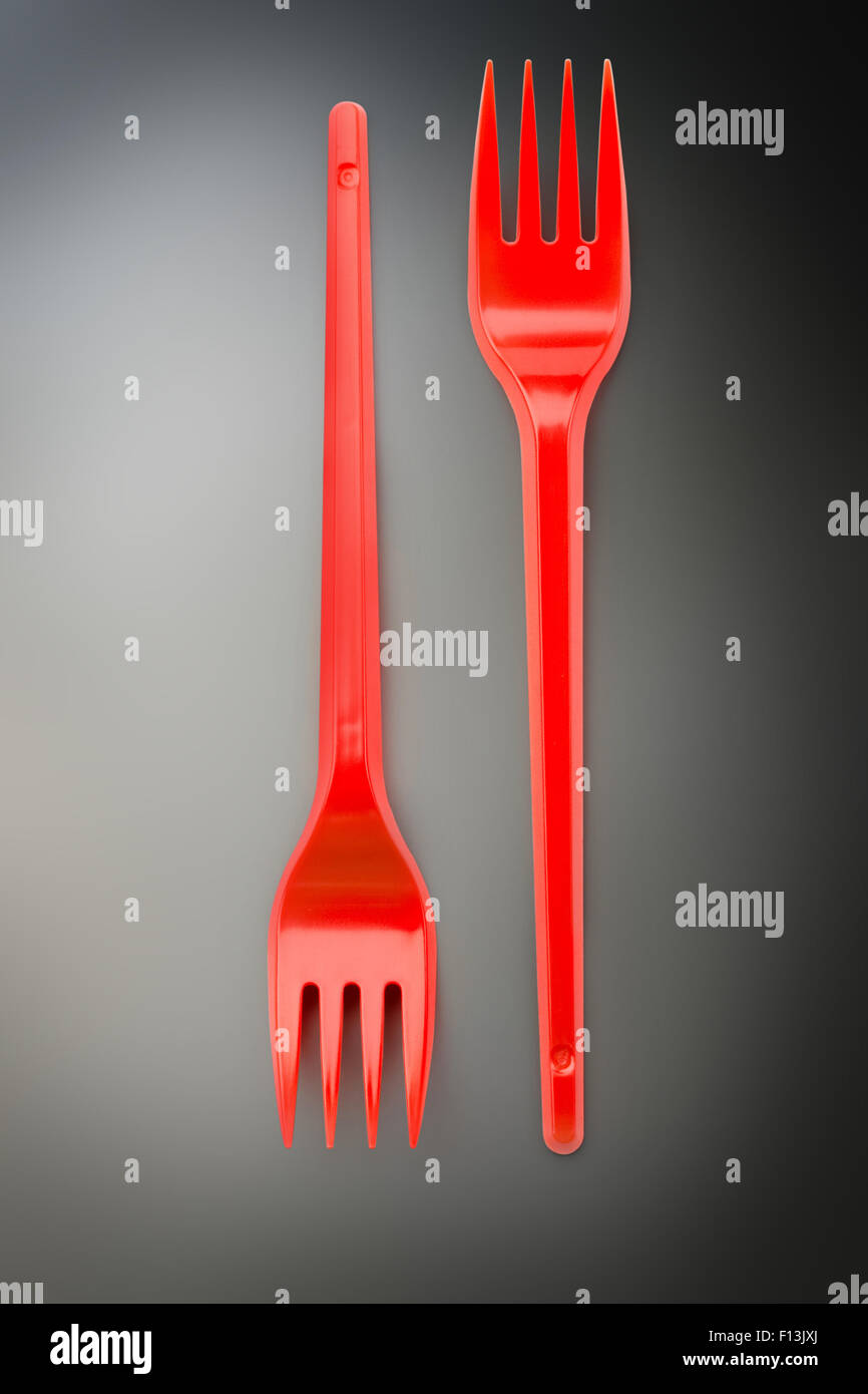 Red plastic forks vertical in close up Stock Photo - Alamy