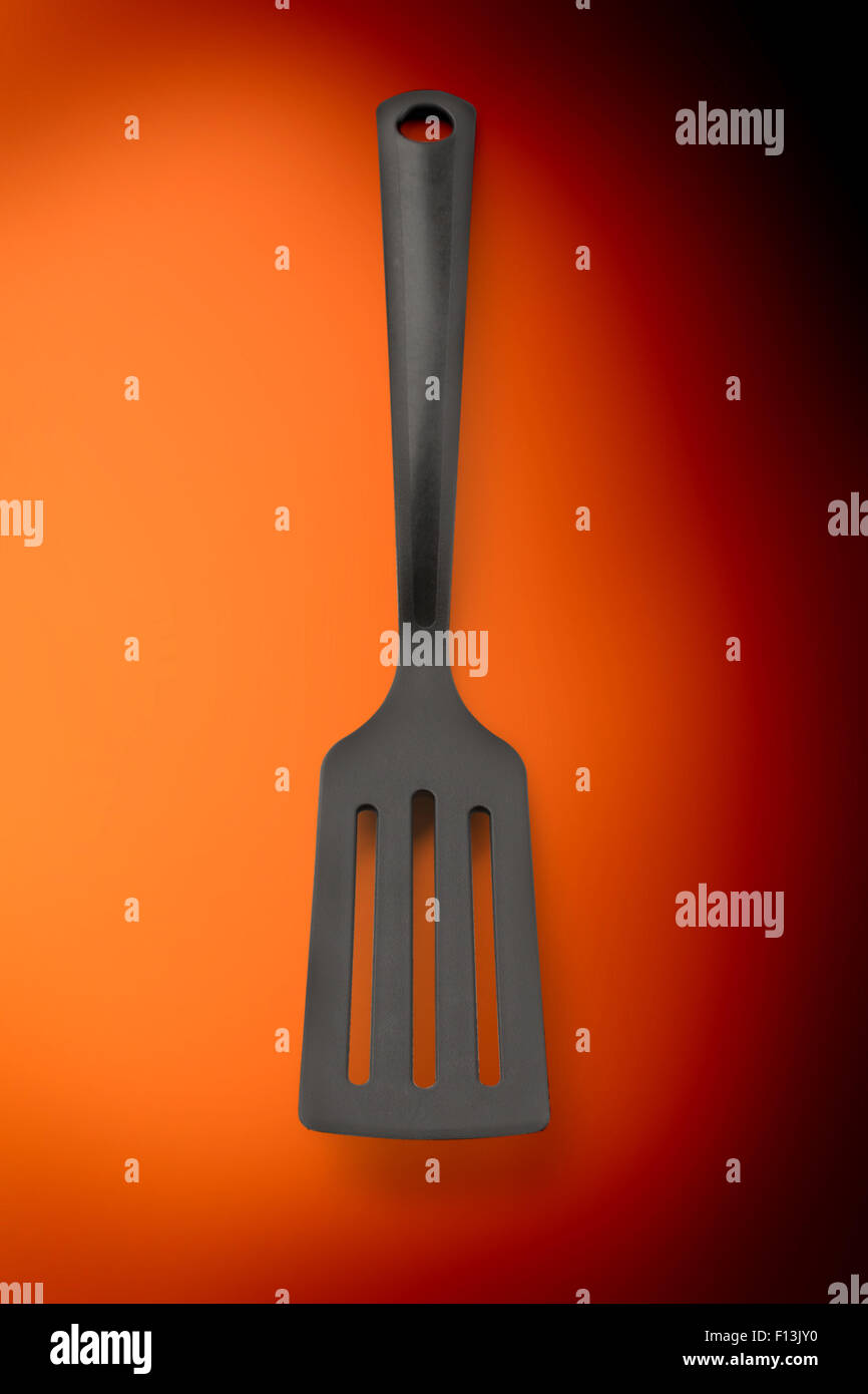 Black plastic kitchen spatula vertical in closeup Stock Photo - Alamy