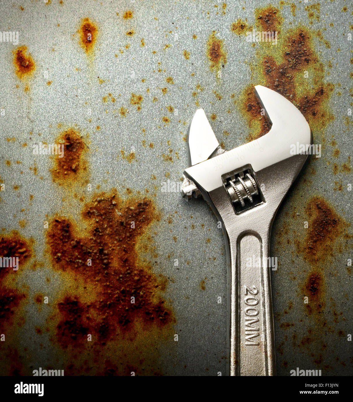 Steel spanner on grey background in closeup Stock Photo - Alamy