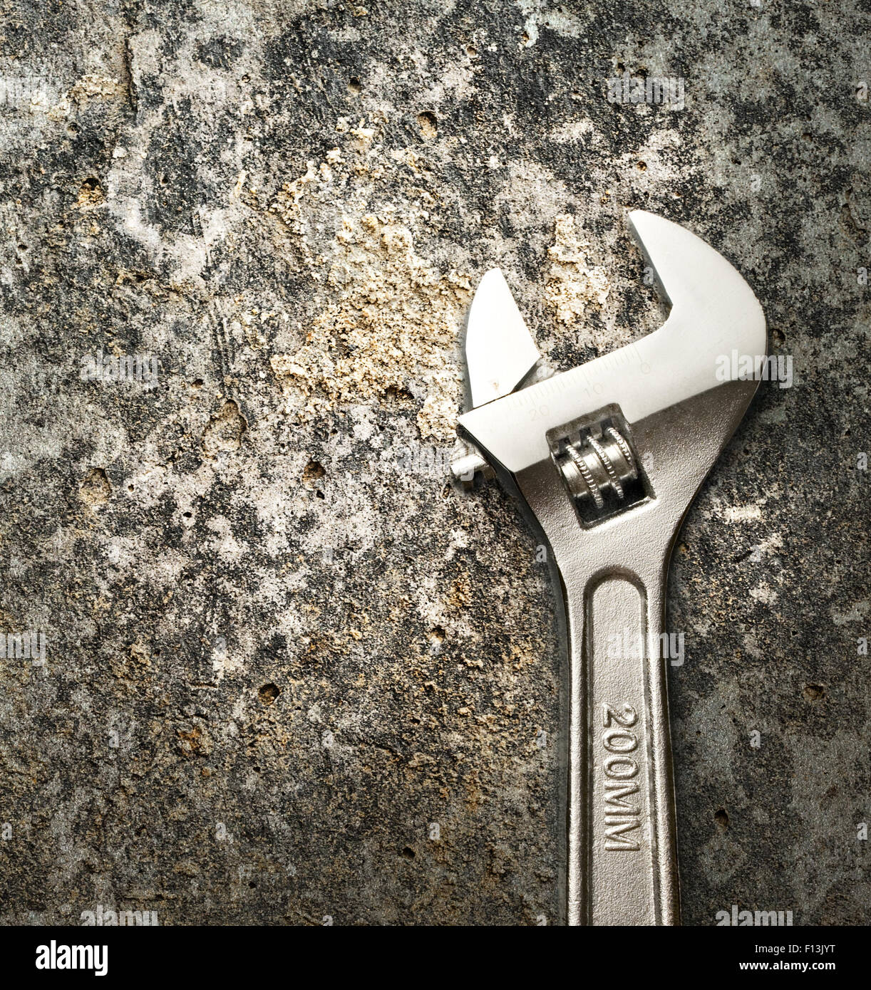 Steel spanner on grey background in closeup Stock Photo - Alamy