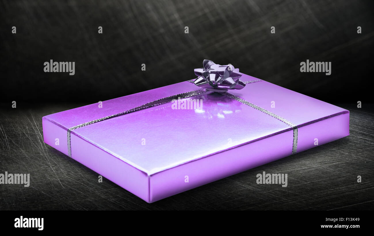 Gift box with bow on steel background Stock Photo - Alamy