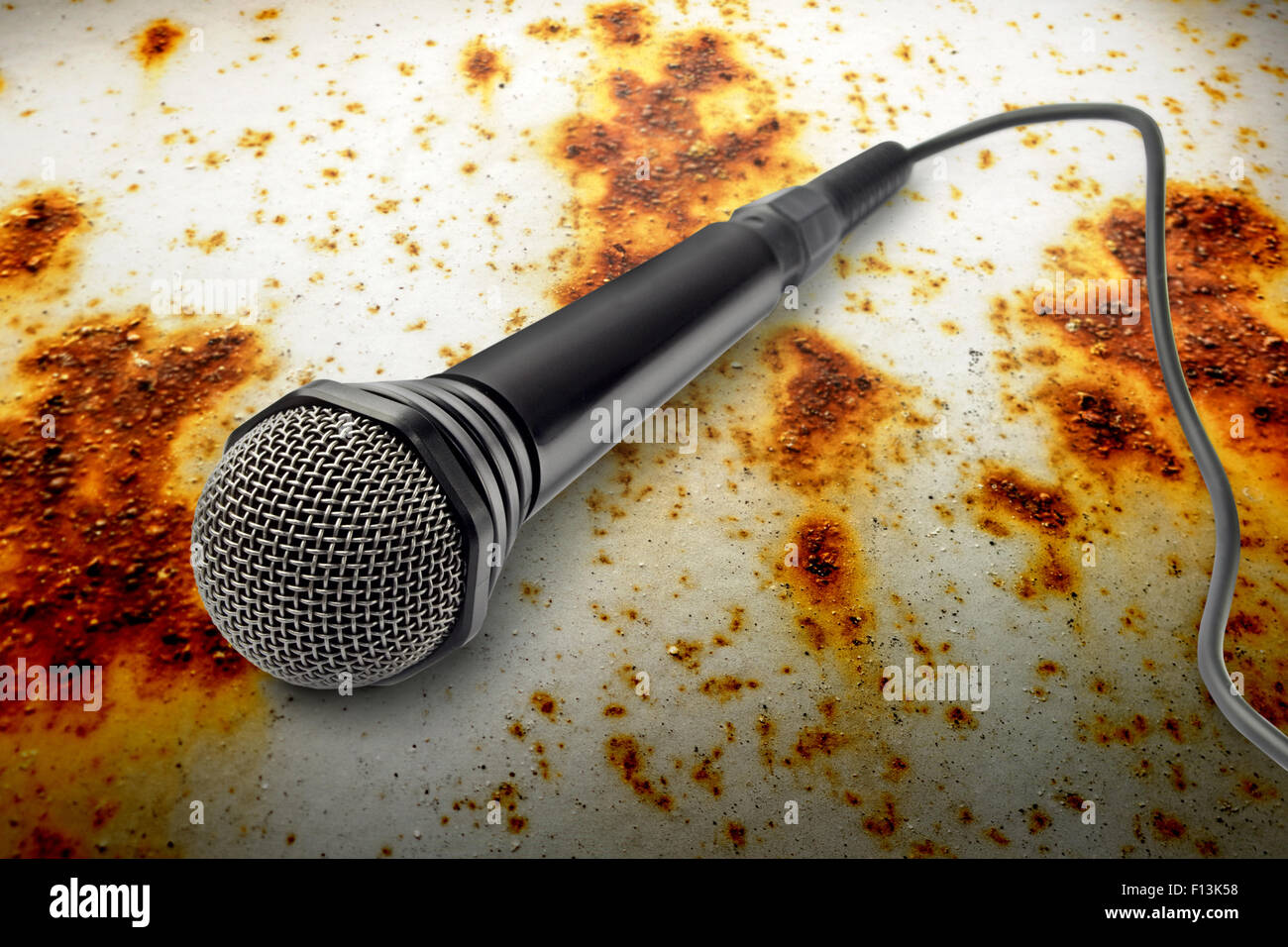 Black microphone on the rusty background closeup Stock Photo - Alamy