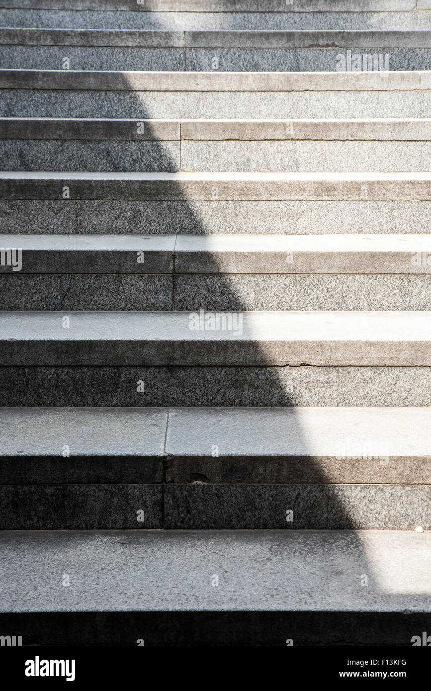 Concrete stairs background with a shadow covering half Stock Photo - Alamy