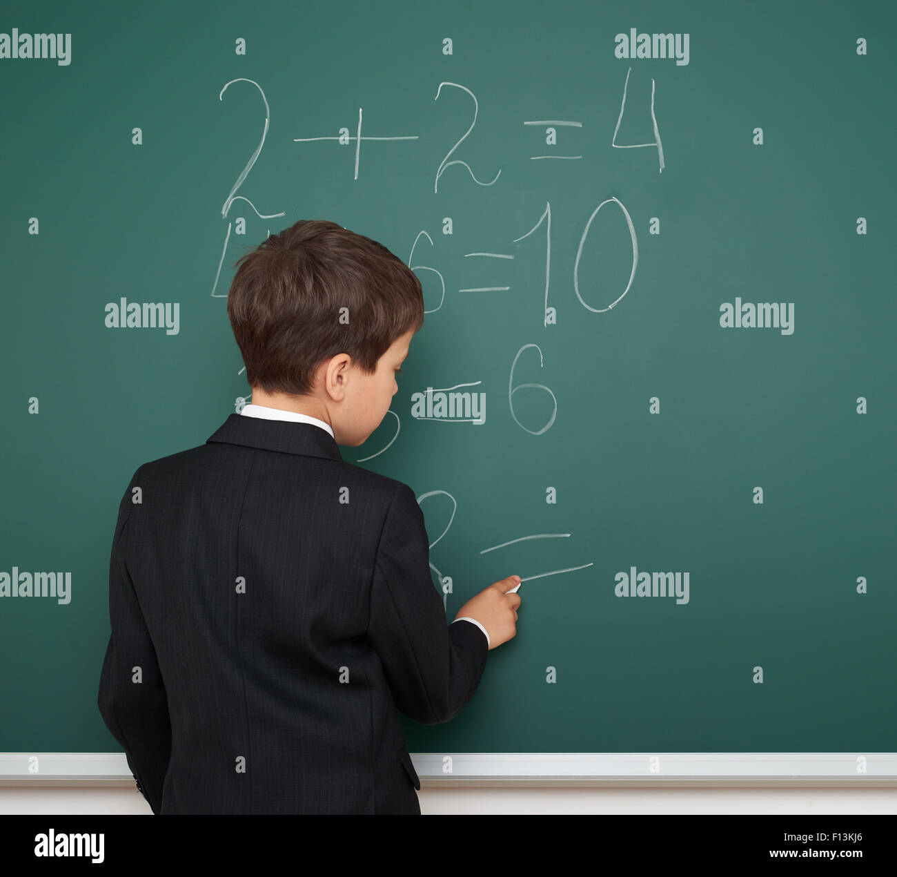School boy solve math on the school board Stock Photo - Alamy