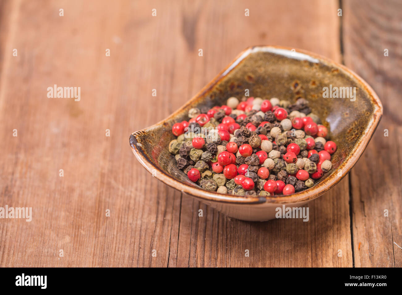 Colorful Peppers Mix in a bowl on wooden table Stock Photo - Alamy