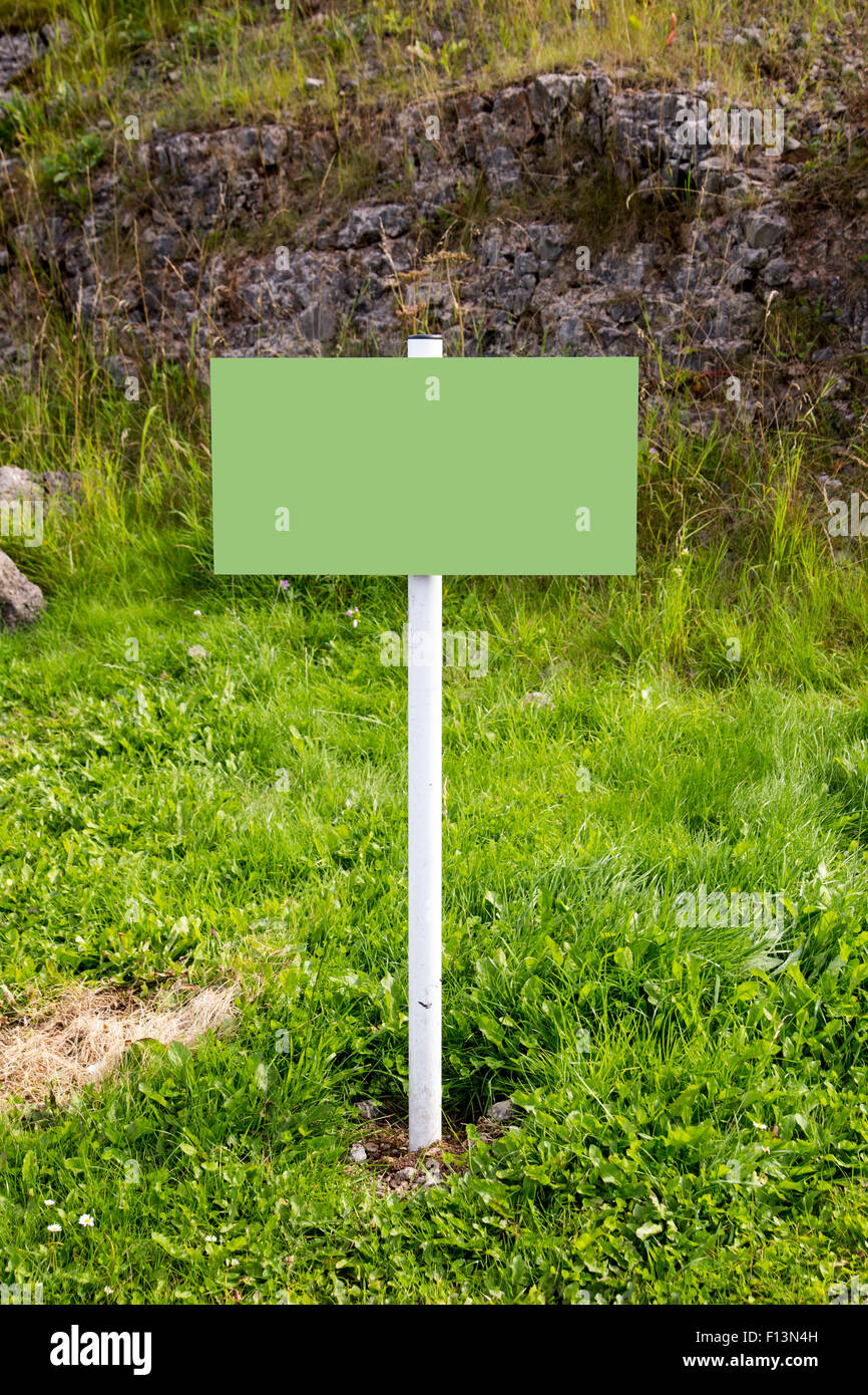 A blank signpost set in a rural landscape of grass and rocks Stock ...