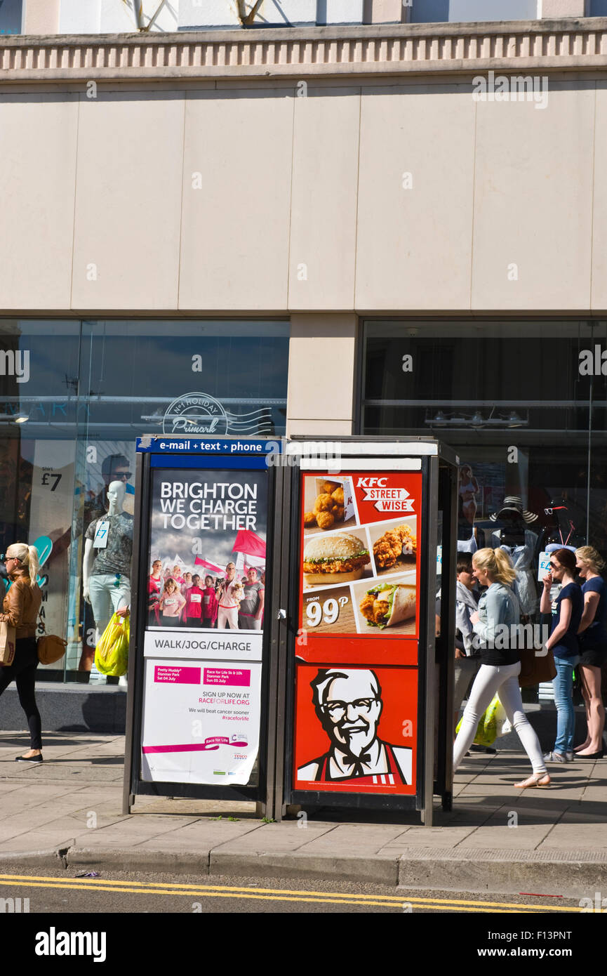 BT phone boxes with advertising for Brighton & KFC on high street in ...