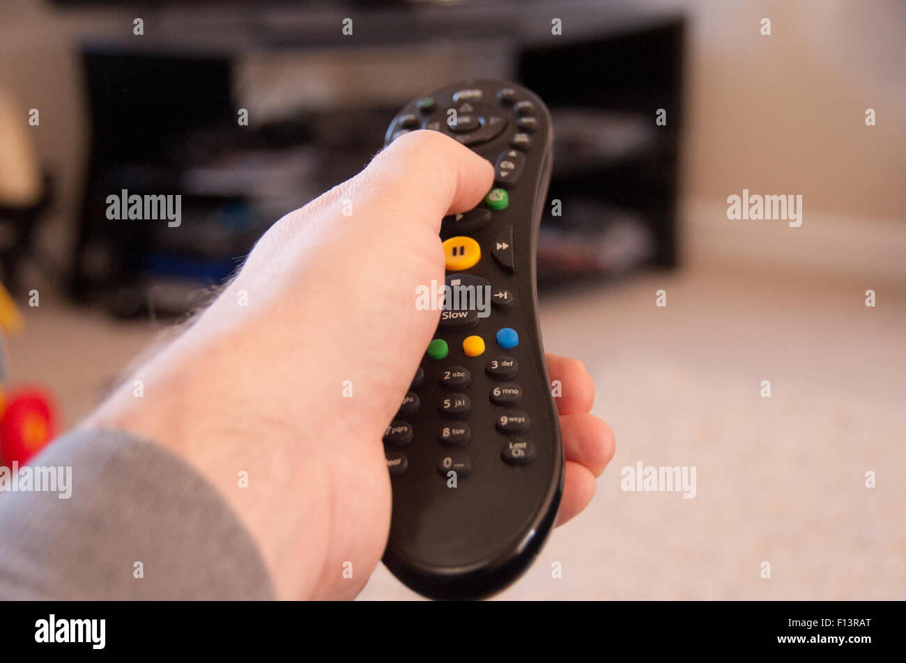 Man holding remote control Stock Photo - Alamy
