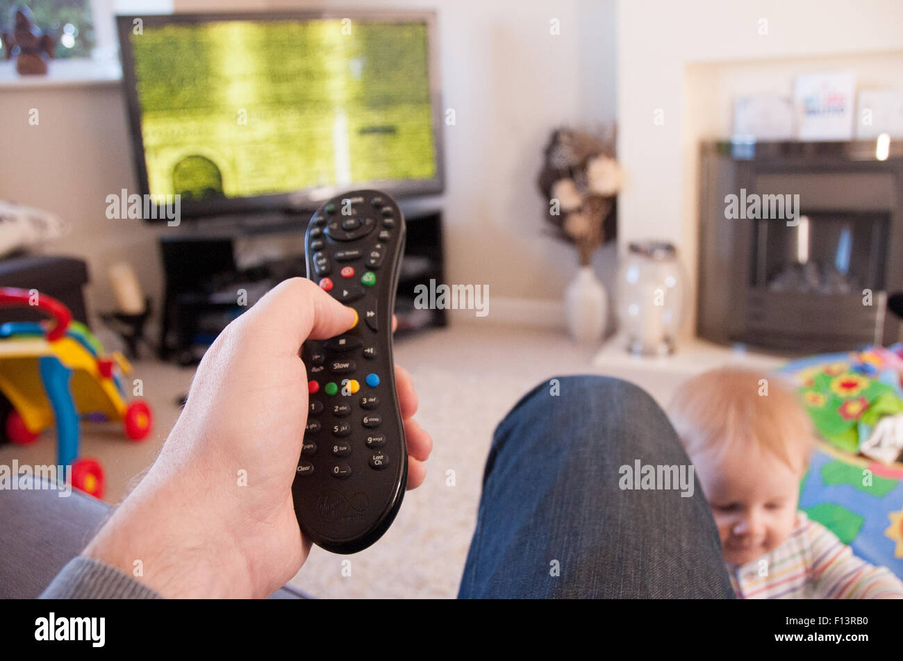 Man holding remote control Stock Photo - Alamy