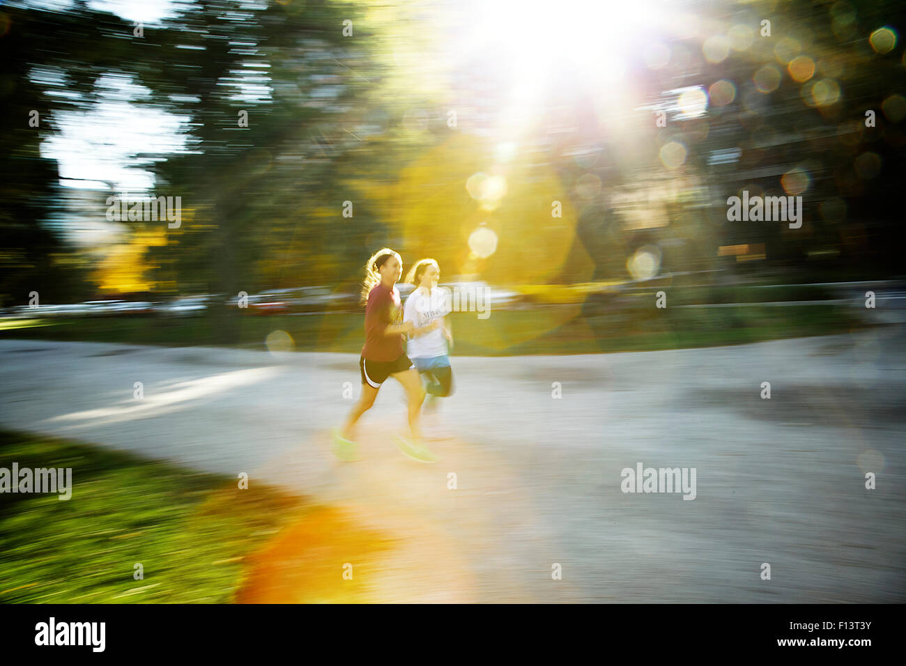 Running woman. Runner jogging in sunny bright light. Female fitness ...