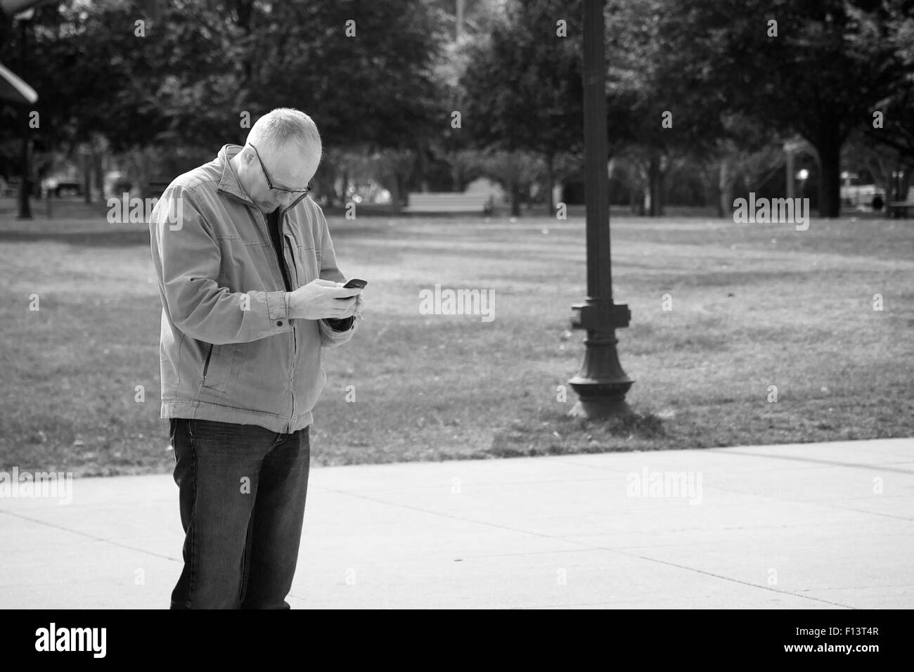 Businessman checking phone Black and White Stock Photos & Images - Alamy