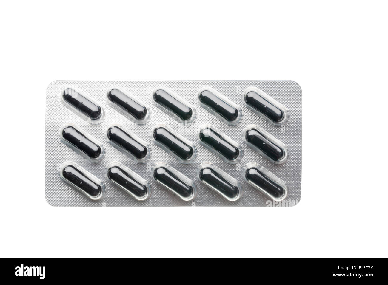 Black capsules in blister pack closeup isolated on white background ...