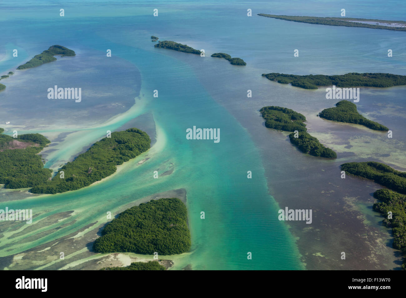 Ocean water flows over pathways of white sand to create a turquoise ...