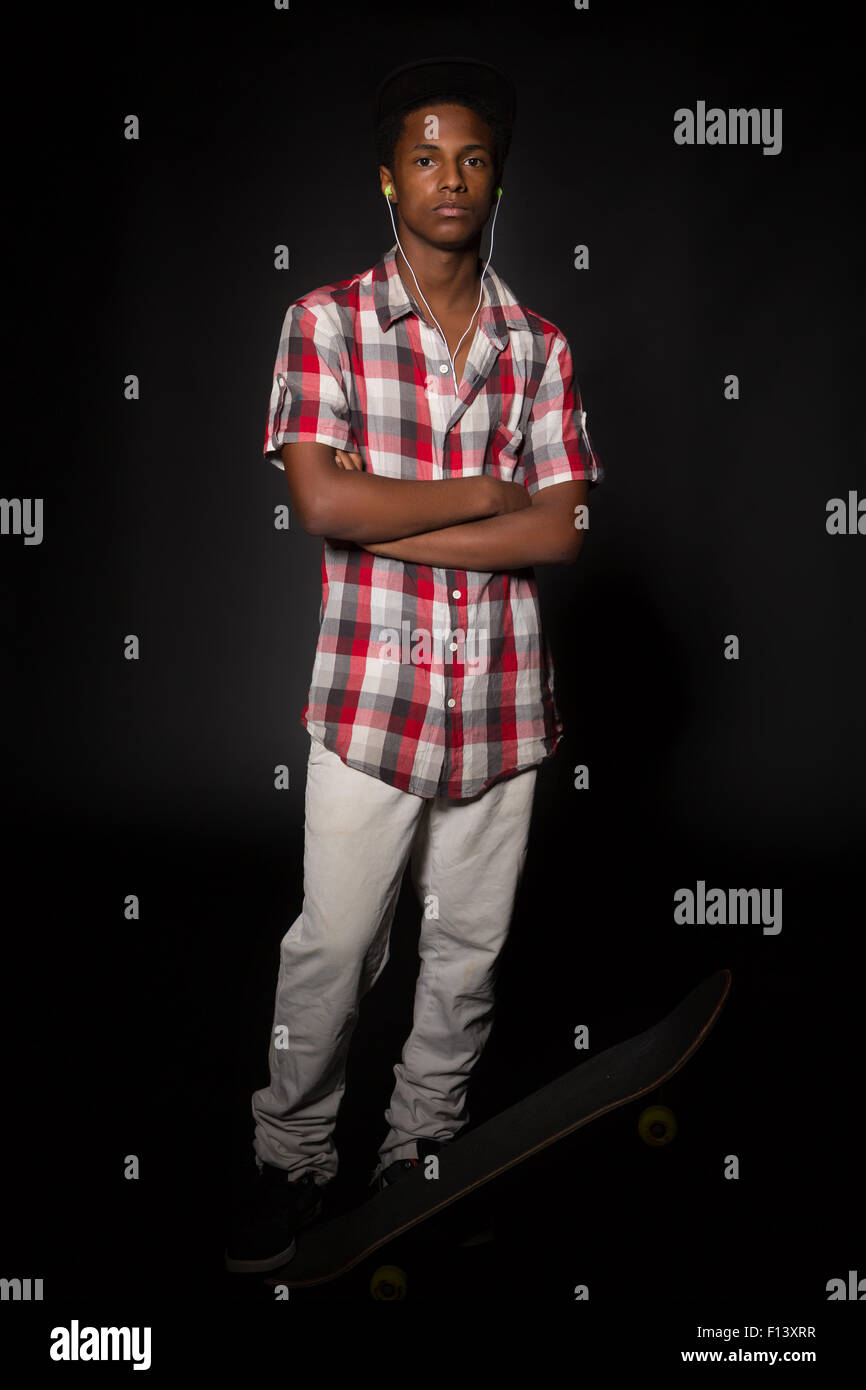 A young black skater posing in studio Stock Photo - Alamy