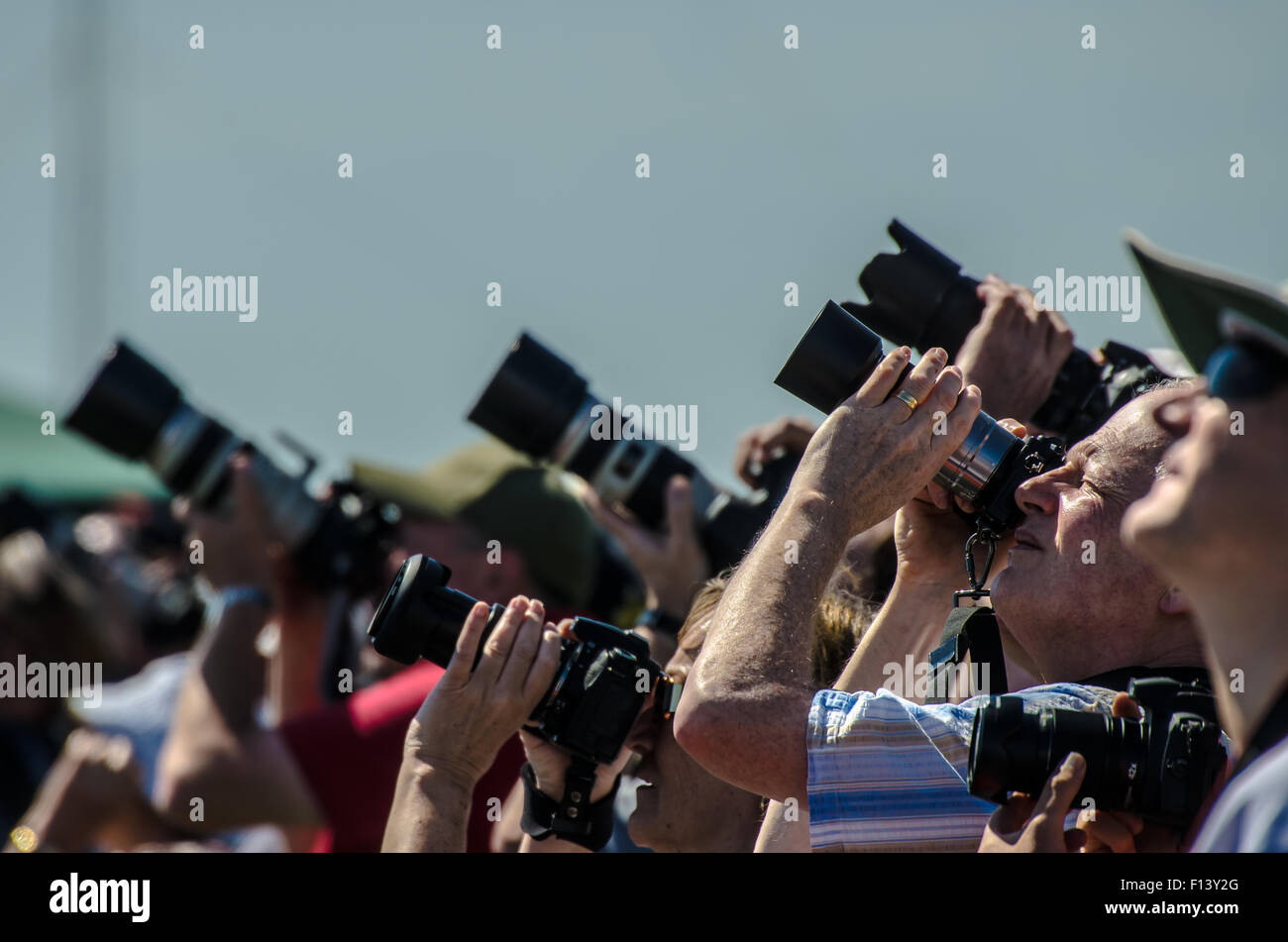 A line of photographers in the crowd at Shoreham Airshow 2015. Cameras ...
