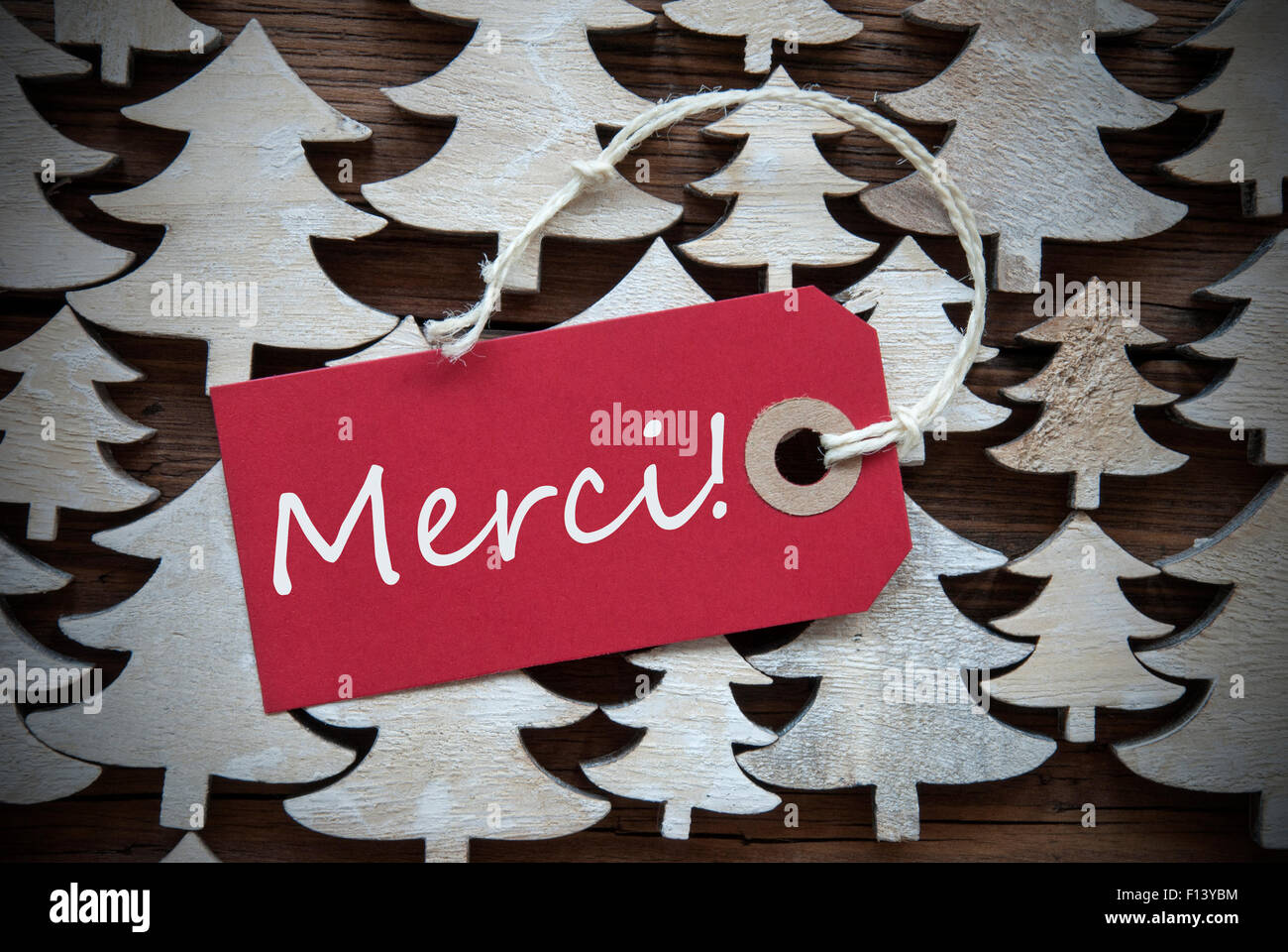 Red Christmas Label With Merci Means Thank You Stock Photo - Alamy