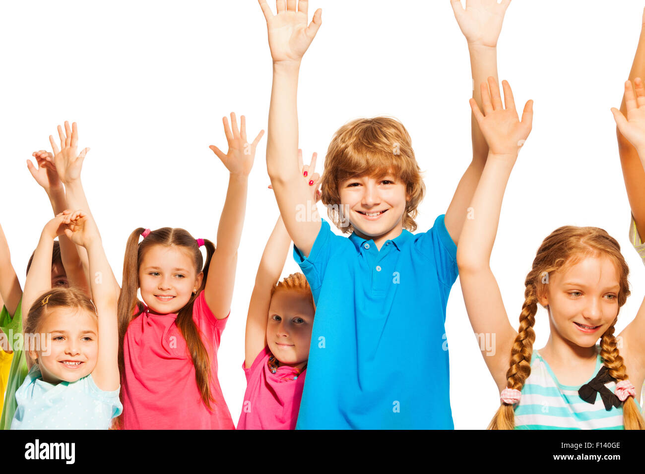 Cute kids standing on white with lifted hands Stock Photo - Alamy