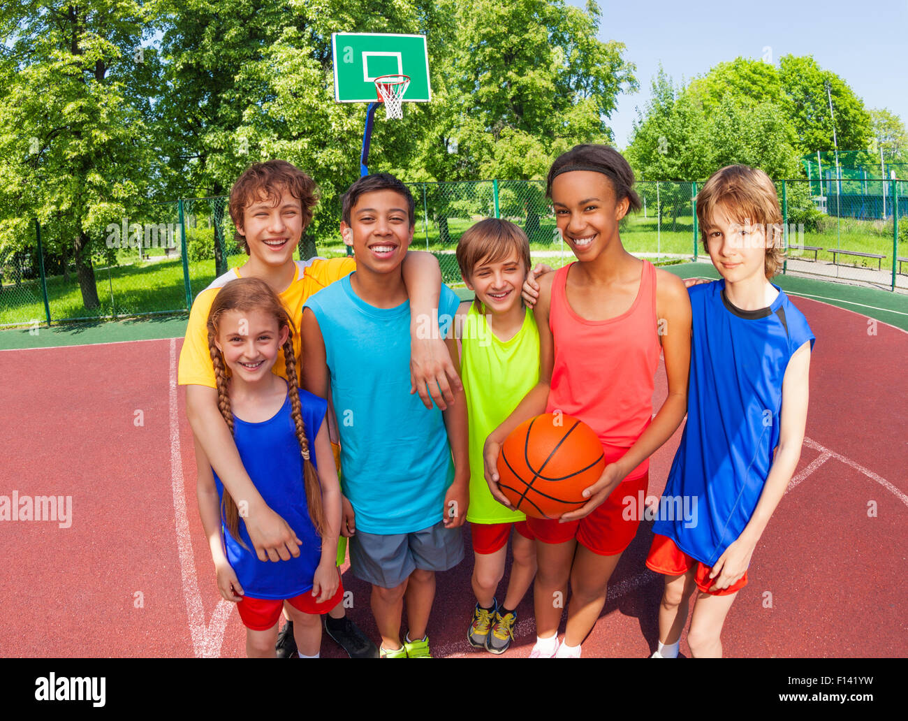Happy basketball team stand in hug after game Stock Photo - Alamy