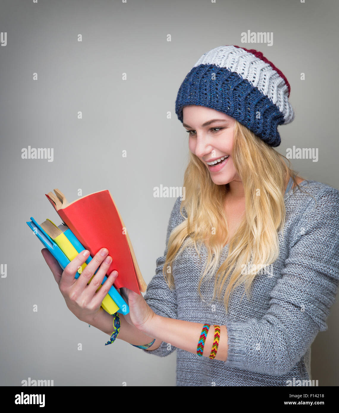 Portrait of beautiful stylish student girl reading exciting book over ...