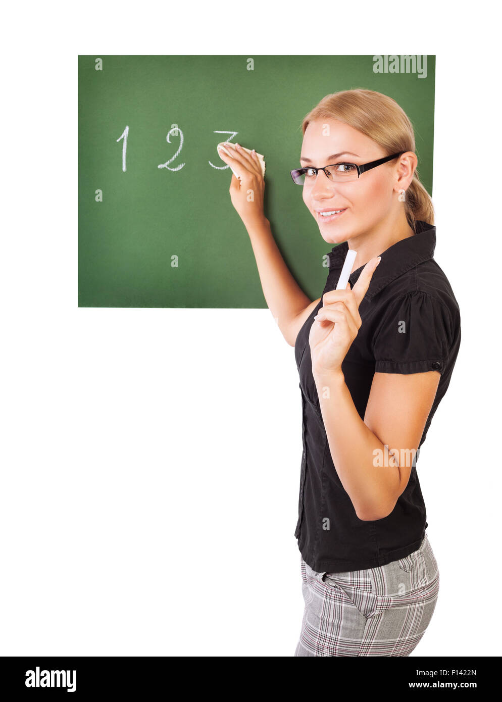 Young beautiful smart teacher standing near green chalkboard isolated ...
