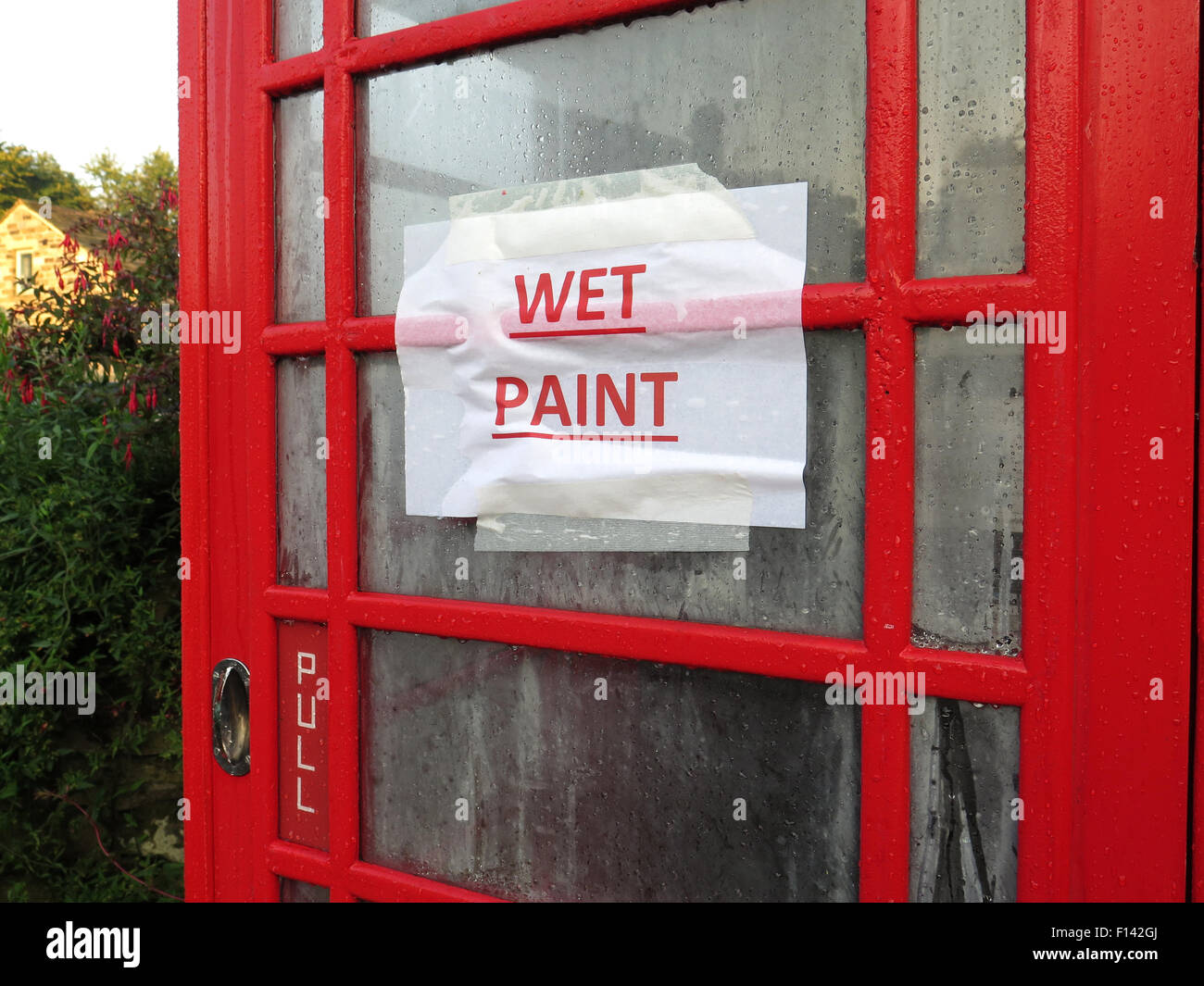 Wet Paint sign on a Telephone Box Stock Photo - Alamy