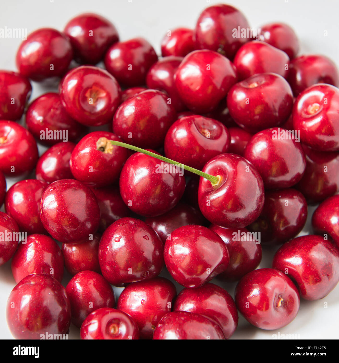 Bowl of red fresh cerries on a white background Stock Photo - Alamy