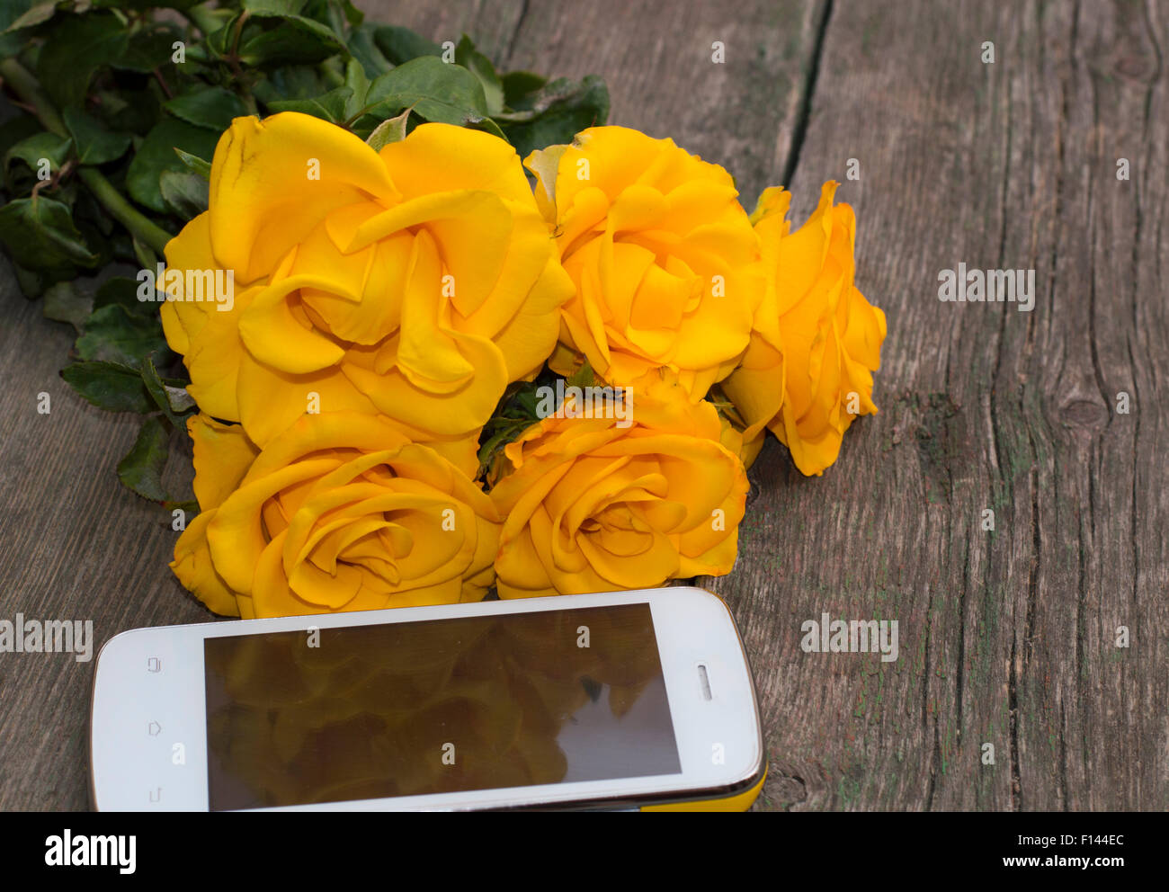 bouquet of yellow roses and their reflection in the phone Stock Photo ...