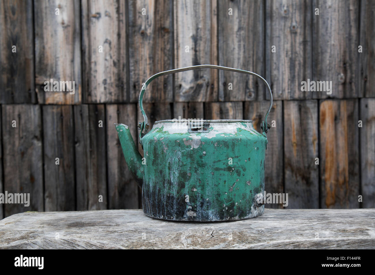 Old kettle outside log cabin on Svalbard Stock Photo - Alamy