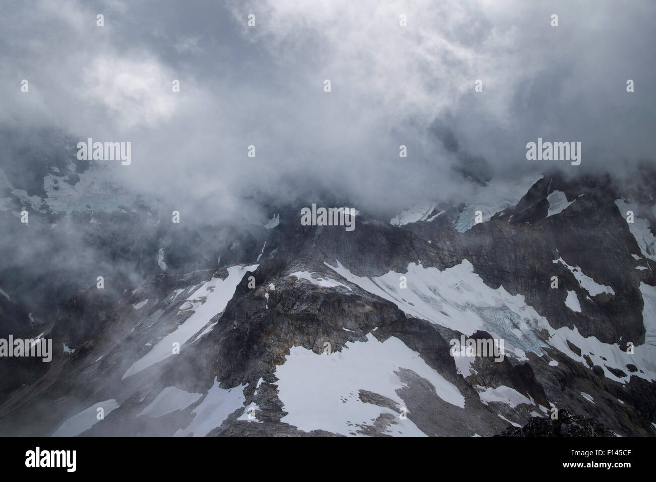 Glaciers and cliffs of the Picket Range in the mist, with Mount Fury ...