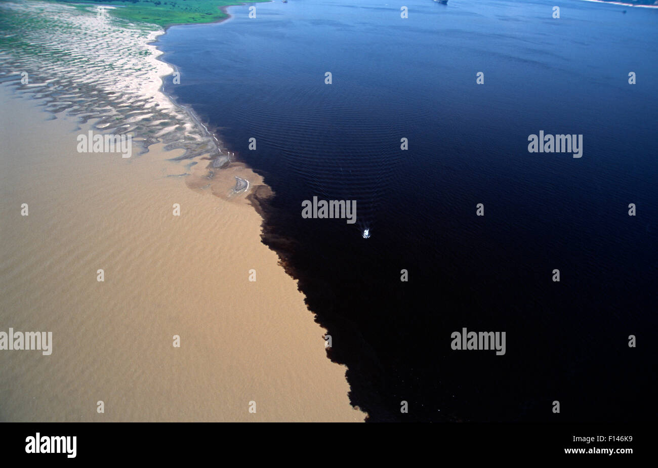 Water from Rio Solimoes meeting water from Rio Negros, Amazonia, Brazil ...