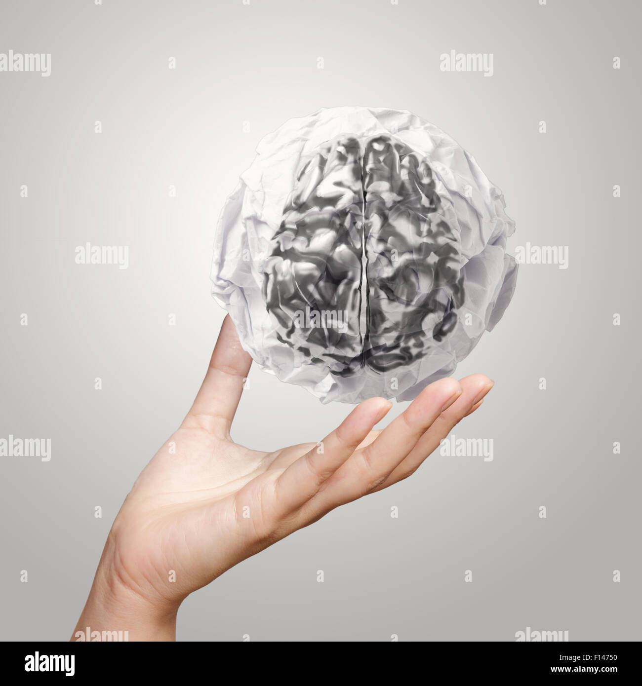 businessman hand showing crumpled paper of 3d metal human brain as ...