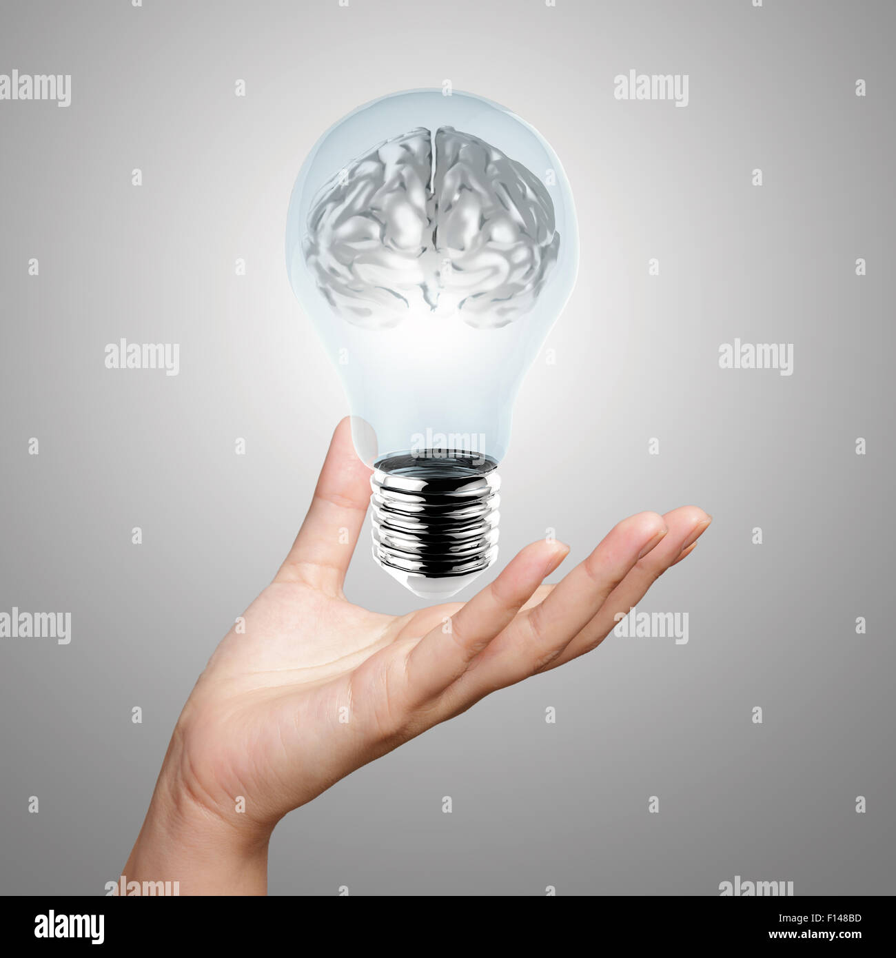 hand showing 3d metal human brain in a lightbulb as creative concept ...