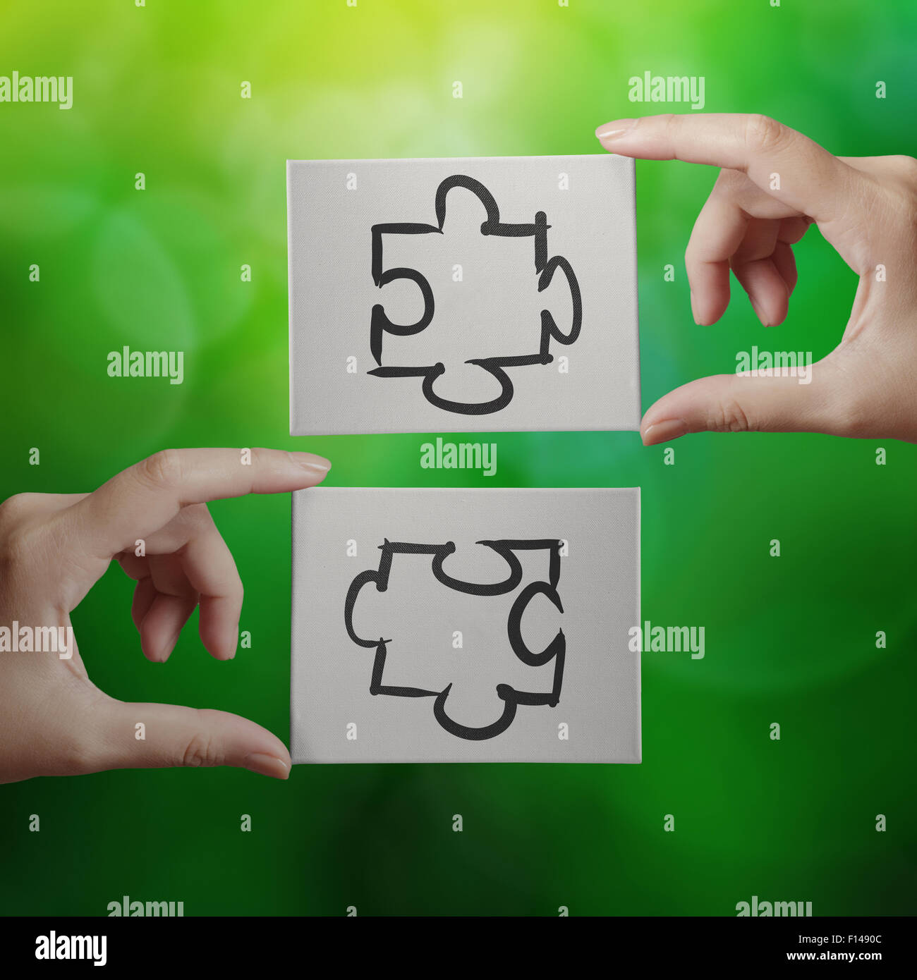 Hand holding hand drawn Partnership Puzzle icon on cavas board as ...