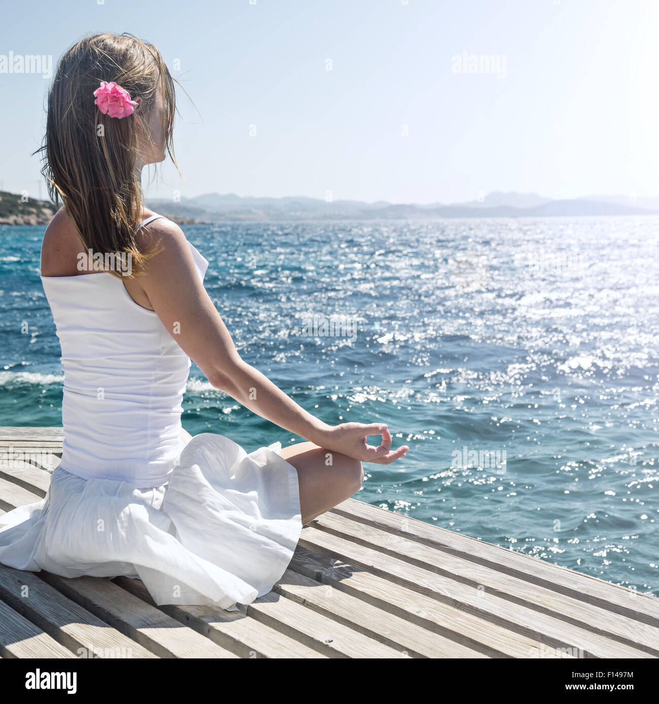 Woman meditating at the sea Stock Photo - Alamy