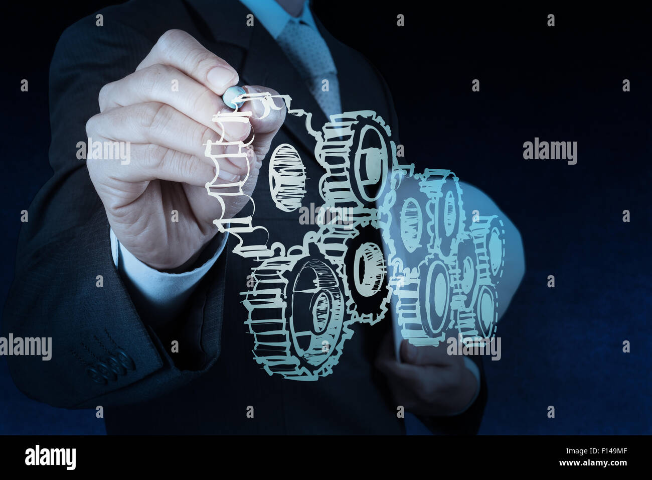 businessman hand draws gear to success concept Stock Photo - Alamy