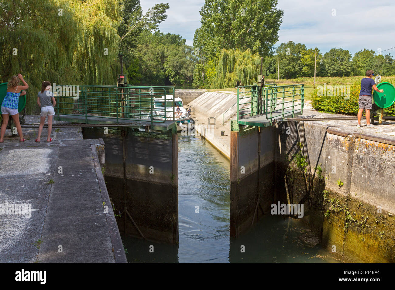 Boat and lock on Canal des Moulins, Vibrac, Charente Maritime, France ...