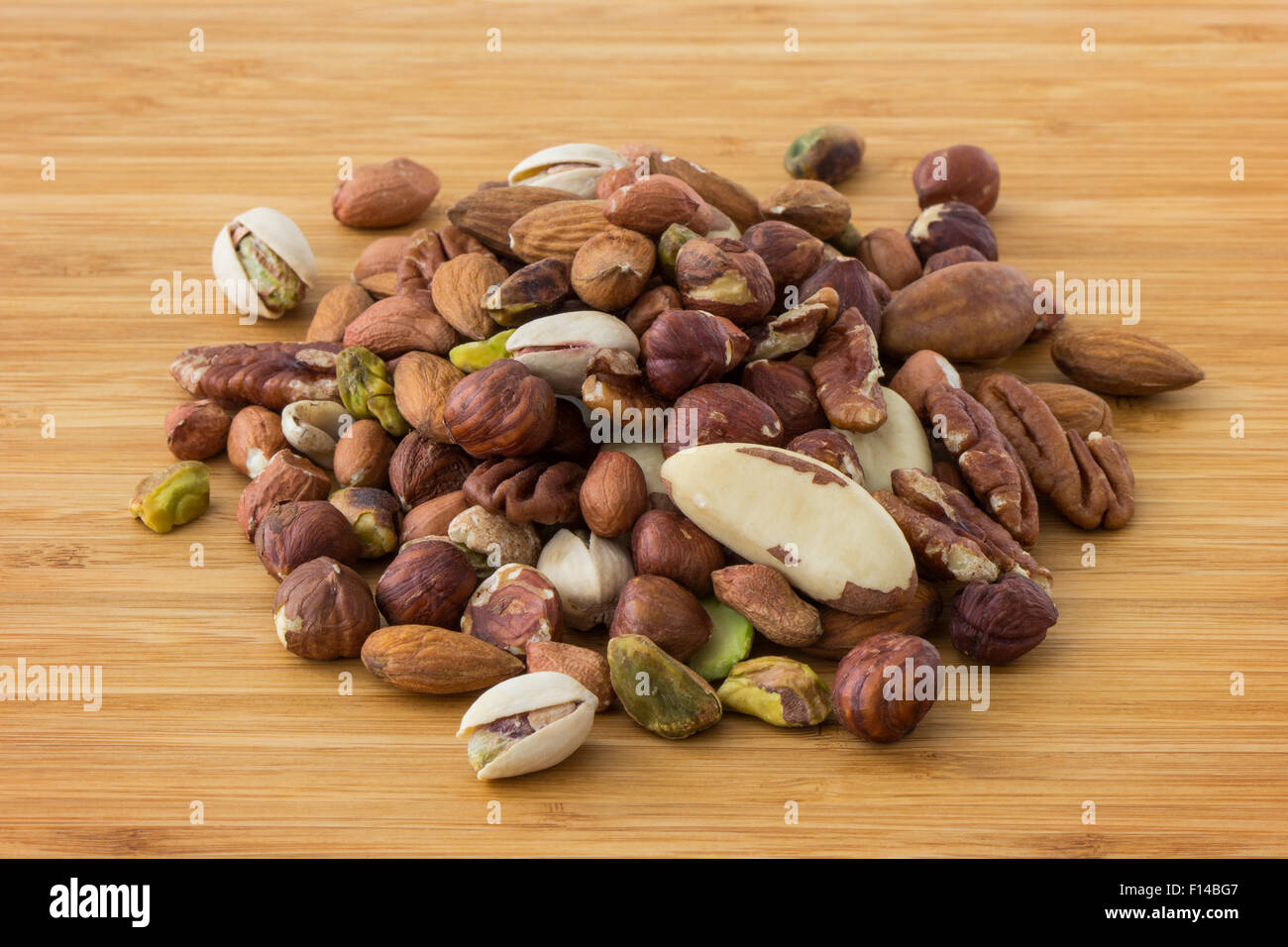Close-up of mixture of several different peanuts on a wooden table ...