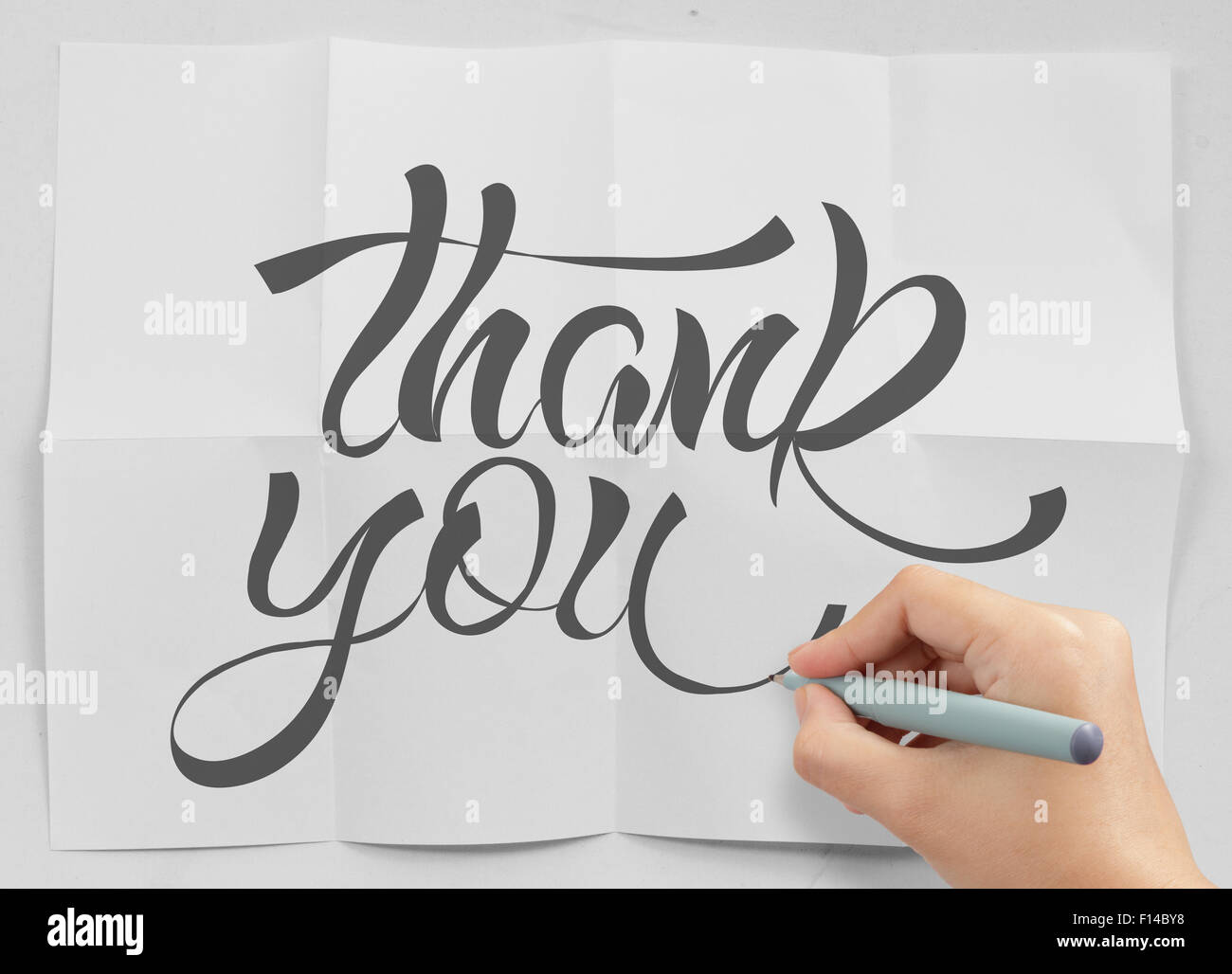 businessman hand drawing design word THANK YOU on crumpled paper as ...