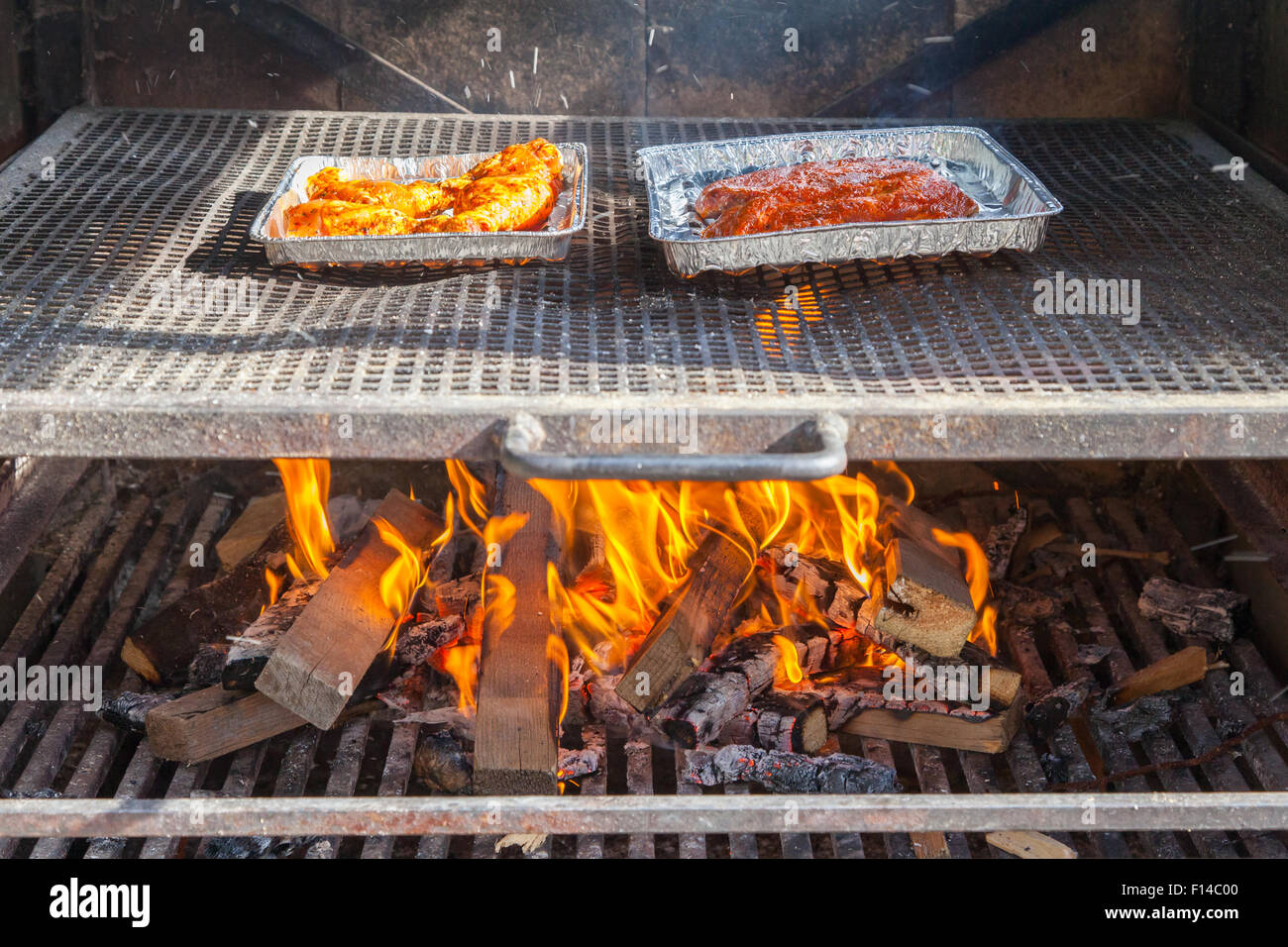 Meat getting ready on a large bbq Stock Photo - Alamy