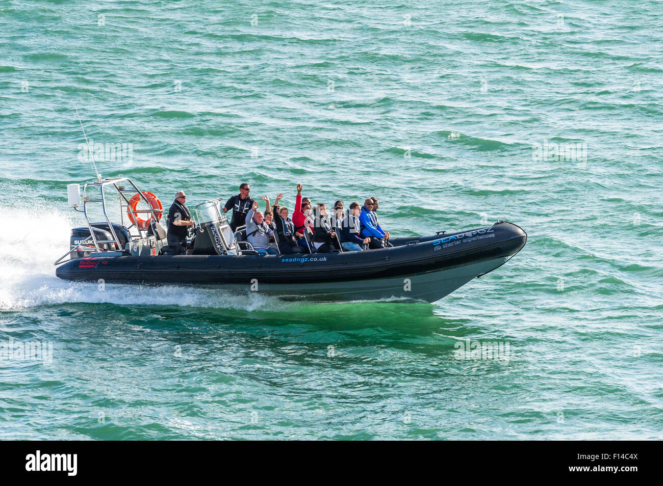 A group of people enjoying a high speed boat ride in the Solent off ...